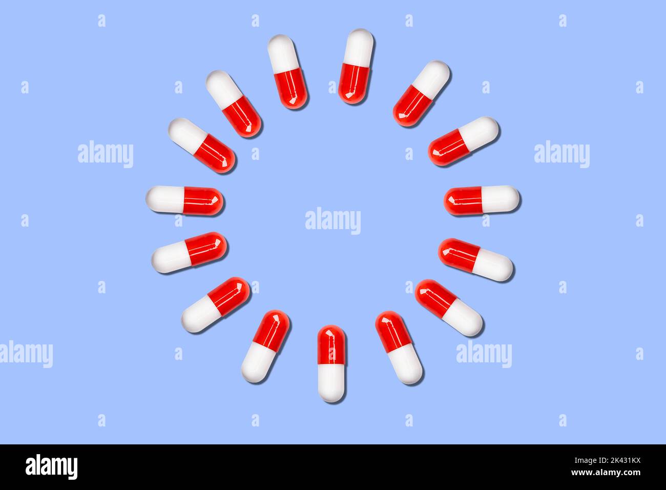 circle of medical capsules on a blue background Stock Photo - Alamy