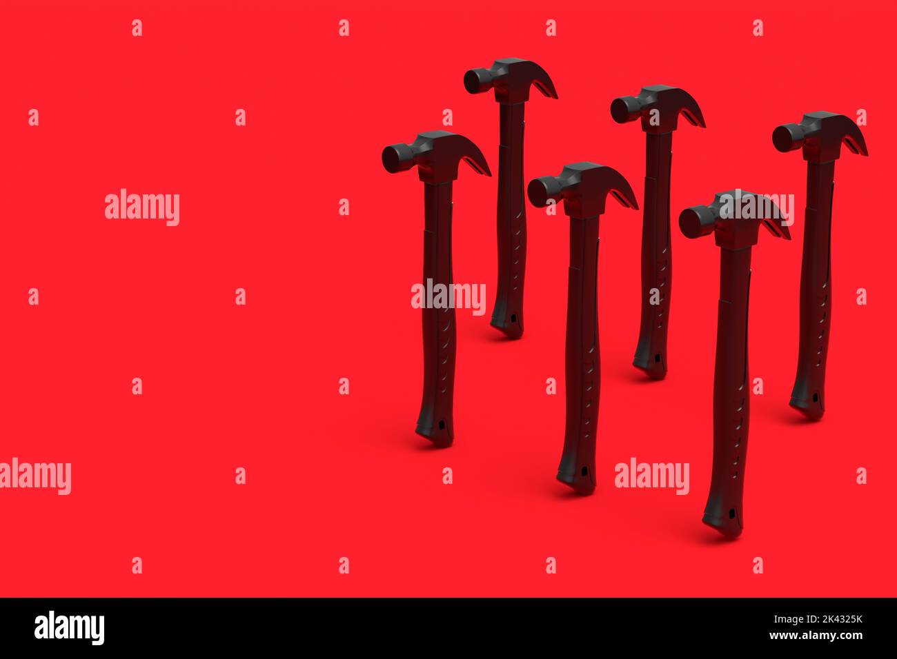 Set of black hammers with a rubberized handle isolated on red ...