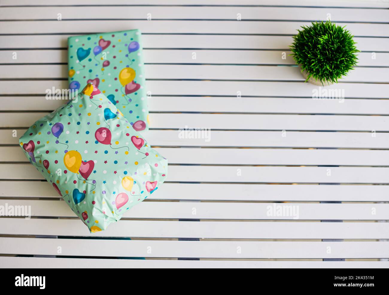 Horizontal shot of two presents wrapped situated on the left side and a ...