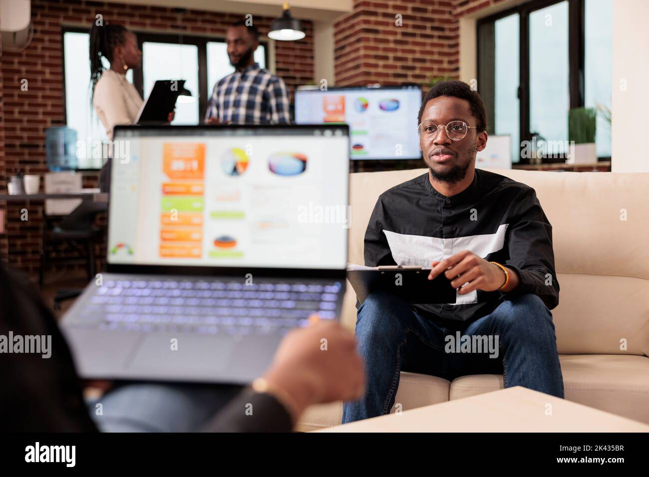 Coworkers doing teamwork collaboration at job, analyzing business charts and graphs to create ...