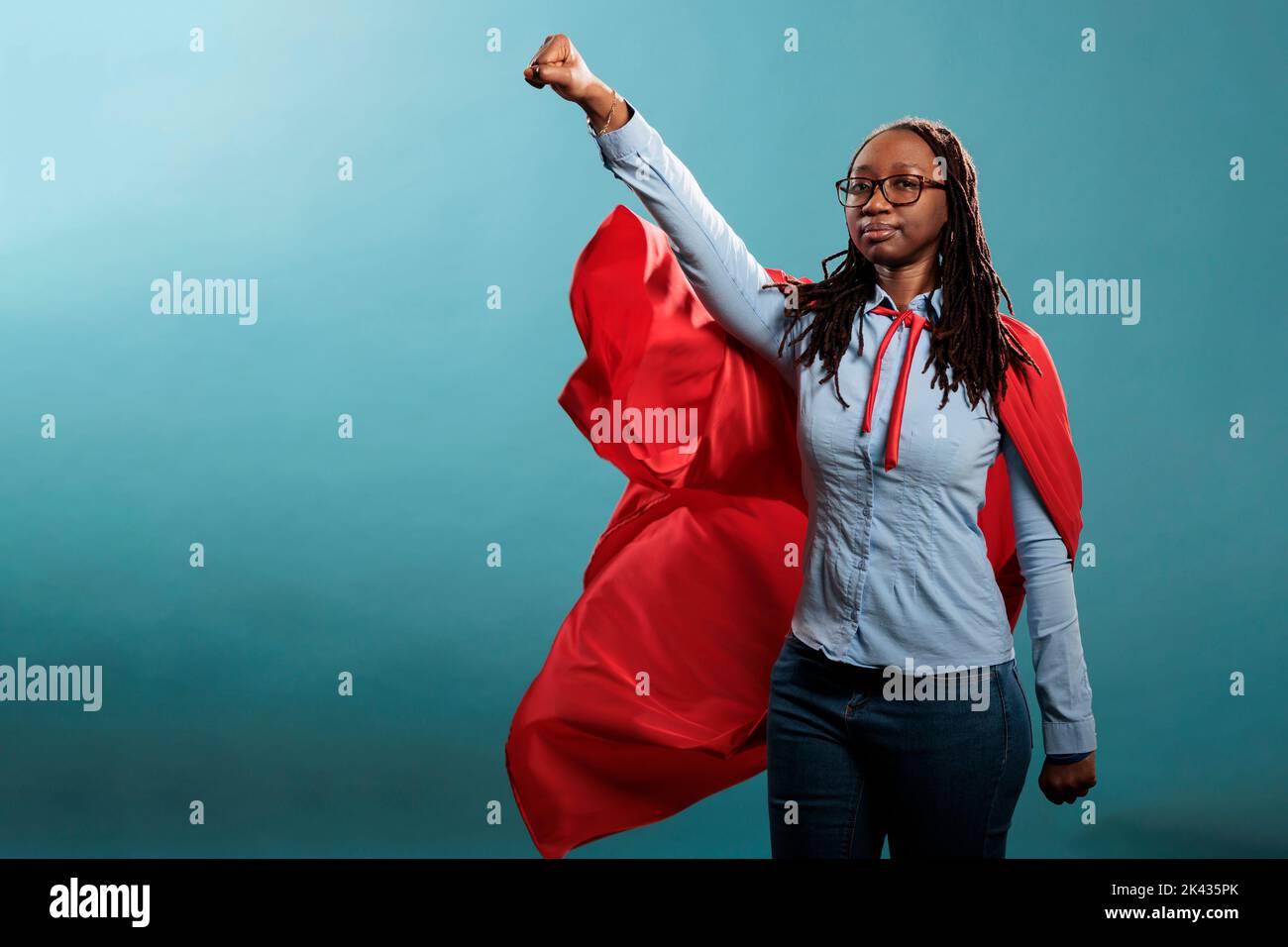 Brave and proud looking young adult superhero woman acting like a ...