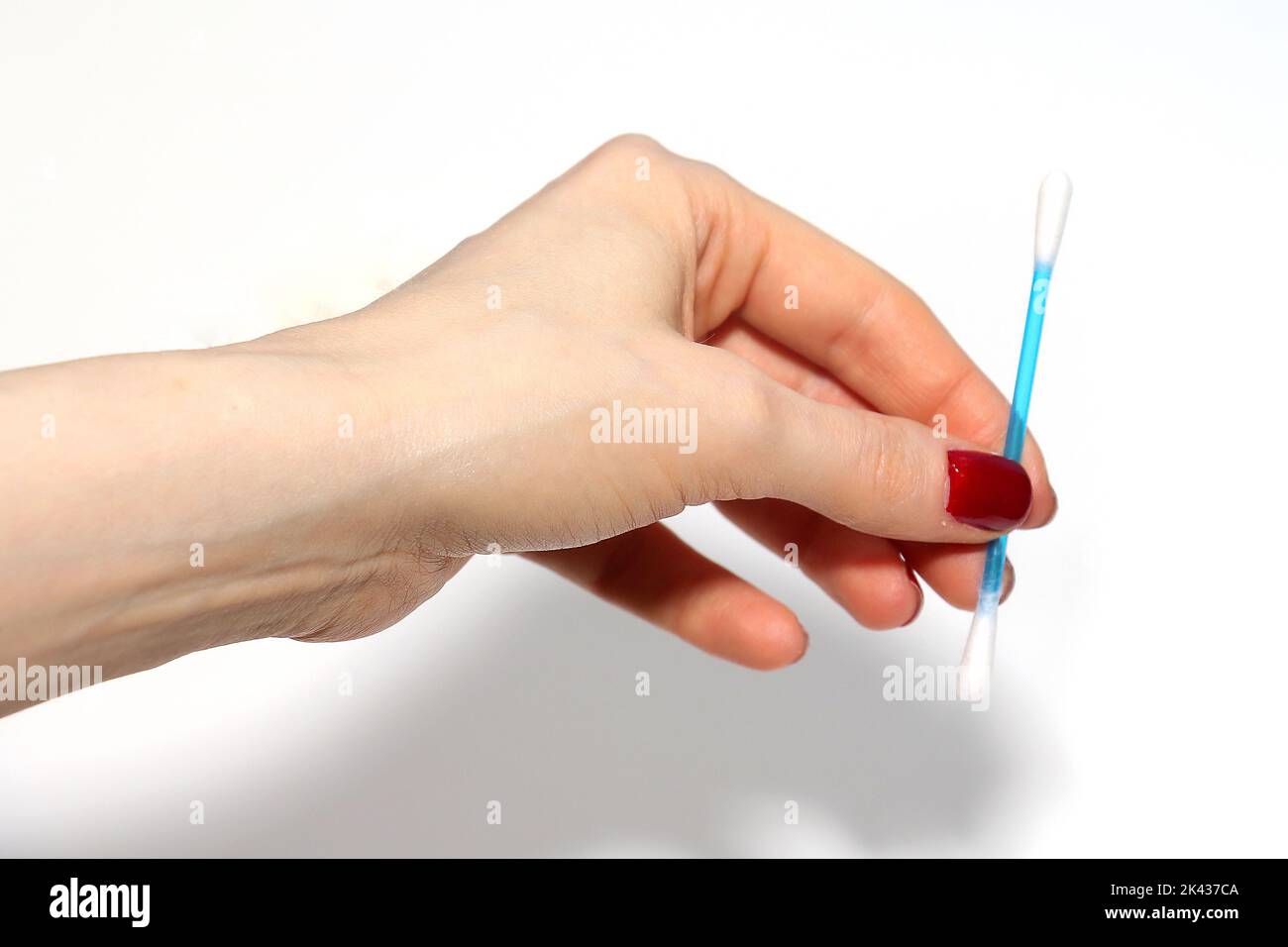 Female hand holding Q-tip with plastic stick Stock Photo - Alamy