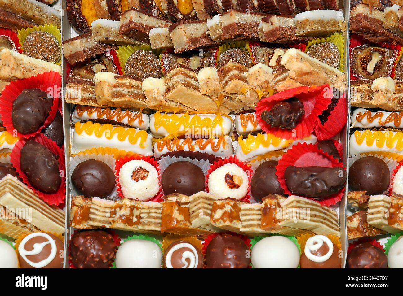 Tasty sugary sweets and cake pieces pile background Stock Photo - Alamy