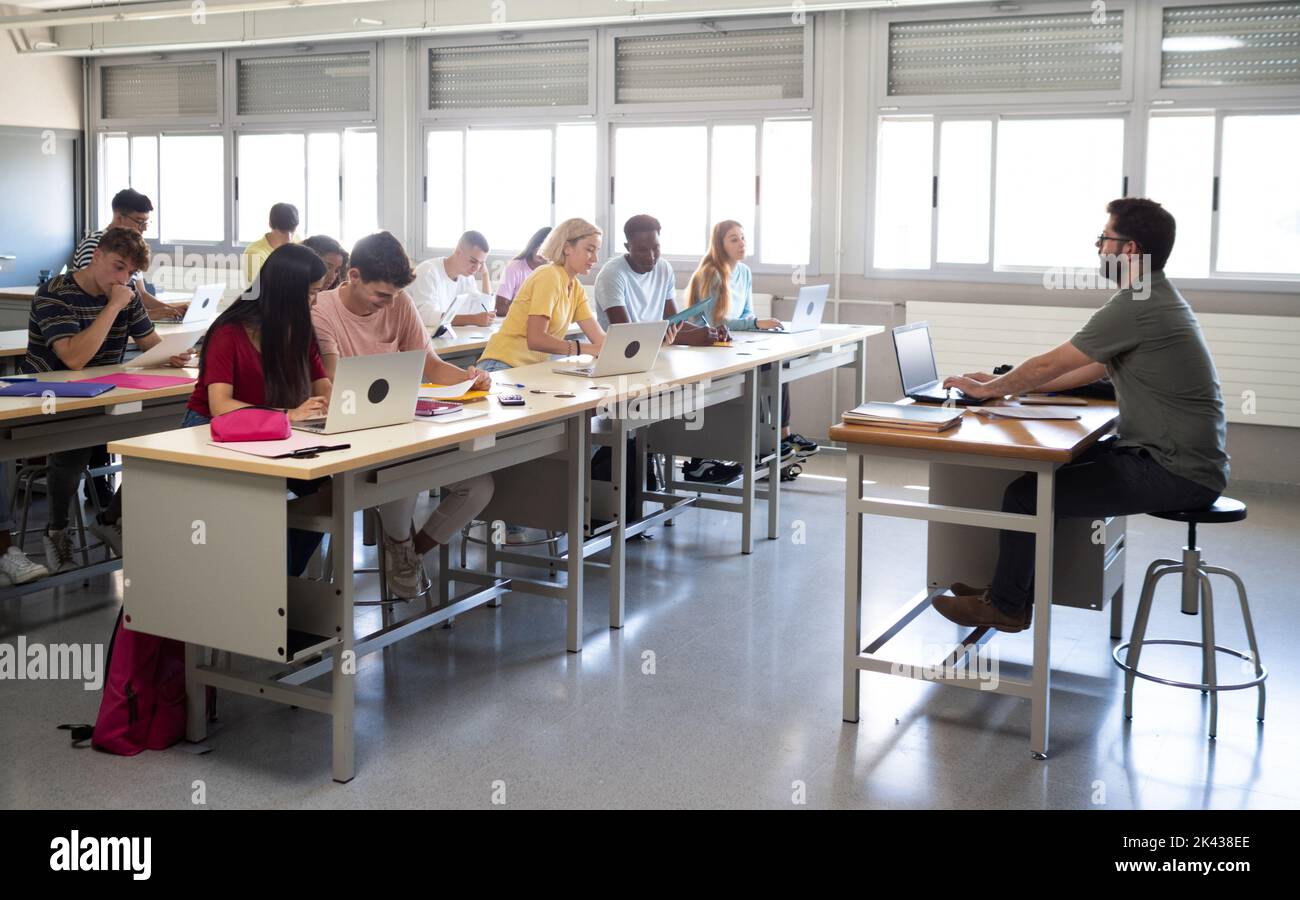 High school class with a male teacher and a group of multi-ethnic ...