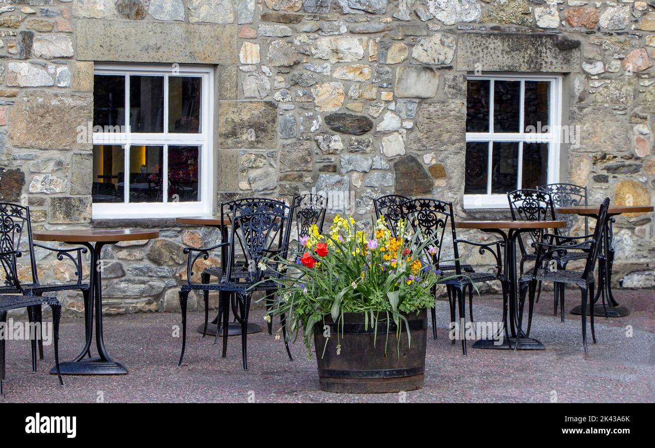 Outside seating area with black metal chairs in a venue which serves ...