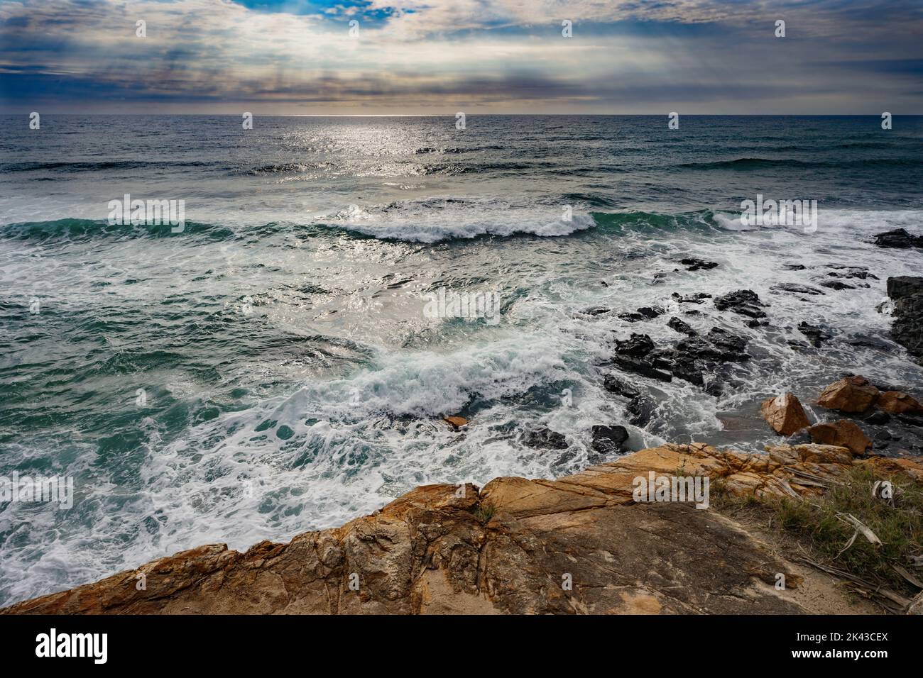 Sun rays shining through the clouds of a threatening storm as Pacific ...