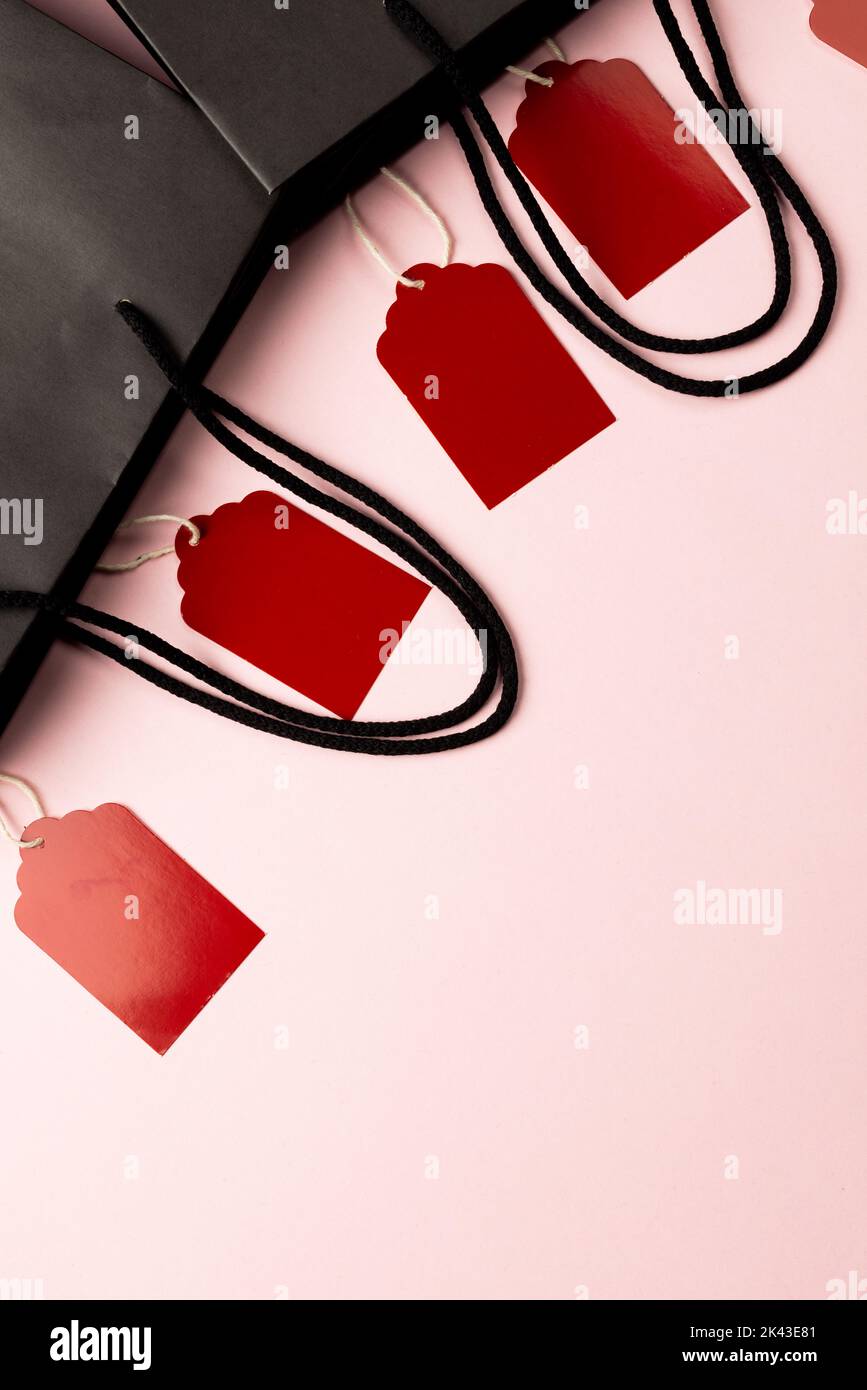 Composition of gift tags and bags with copy space on white background ...