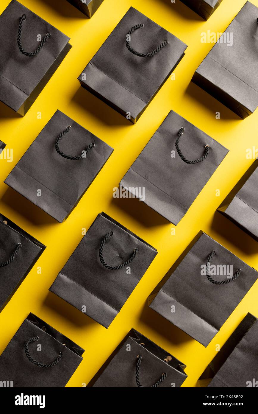 Composition of gray paper shopping bags on yellow background Stock ...