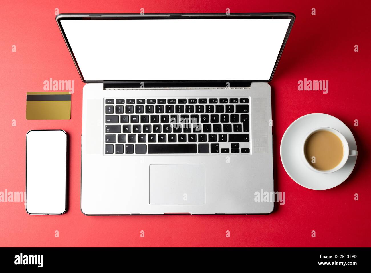 Composition of cup of coffee, smartphone and laptop with copy space on ...