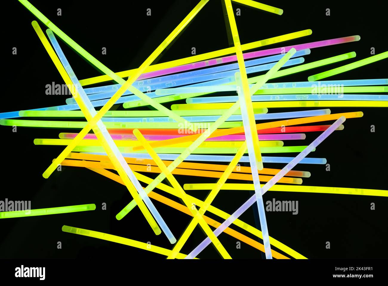 Image of vibrant stack of neon glow sticks scattered over black ...