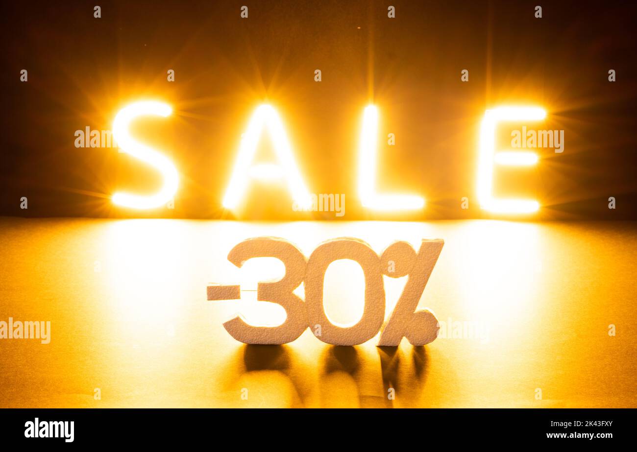 Image of glowing neon minus 30 percent sale text over orange background ...