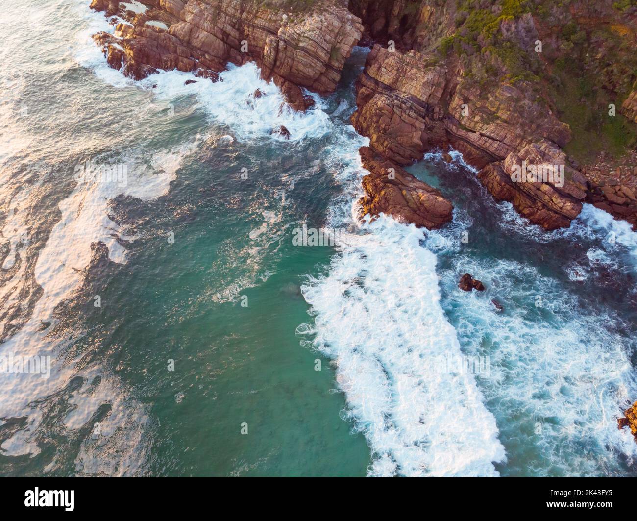 High angle view of sea waves and sea shore with rocky cliff shore Stock ...