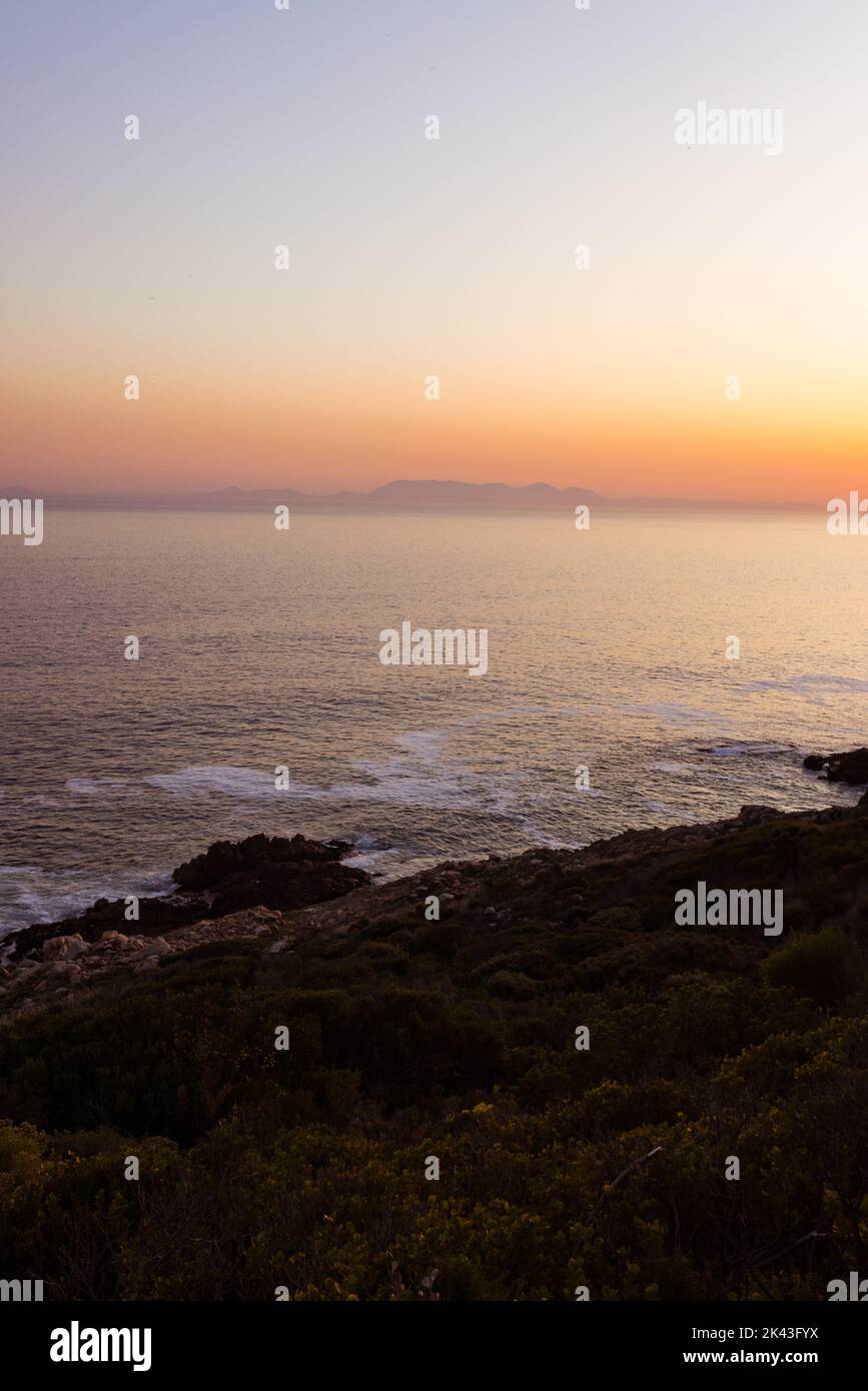 Landscape of sea waves and sea shore with rocks, blue cloudless sky and ...