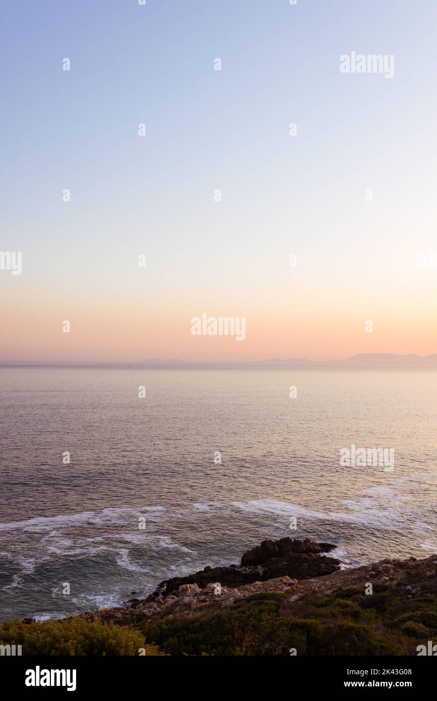 Landscape of sea waves and sea shore with rocks, blue cloudless sky and ...