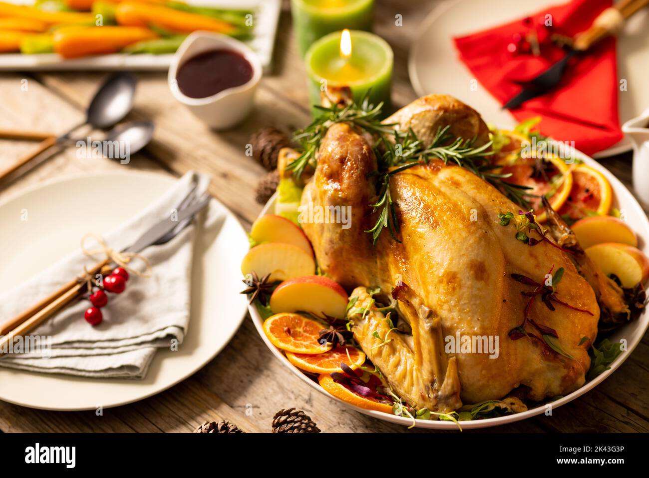 Overhead view of thanksgiving table with roast chicken and vegetables ...