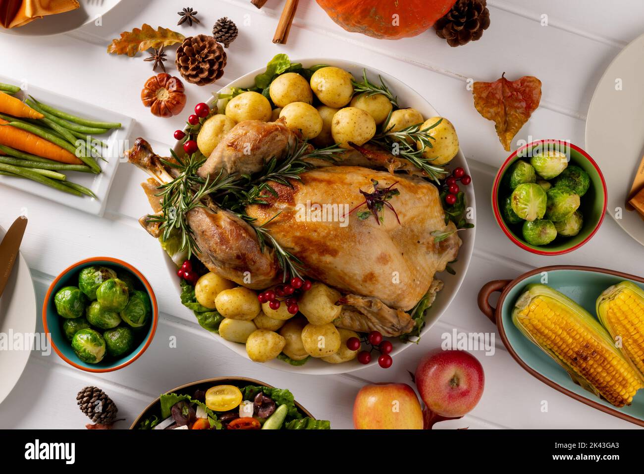Overhead view of thanksgiving table with roast turkey, vegetables and ...