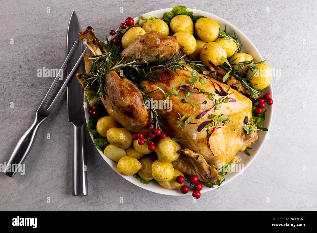 Overhead view of thanksgiving roast turkey with potatoes and cutlery on ...