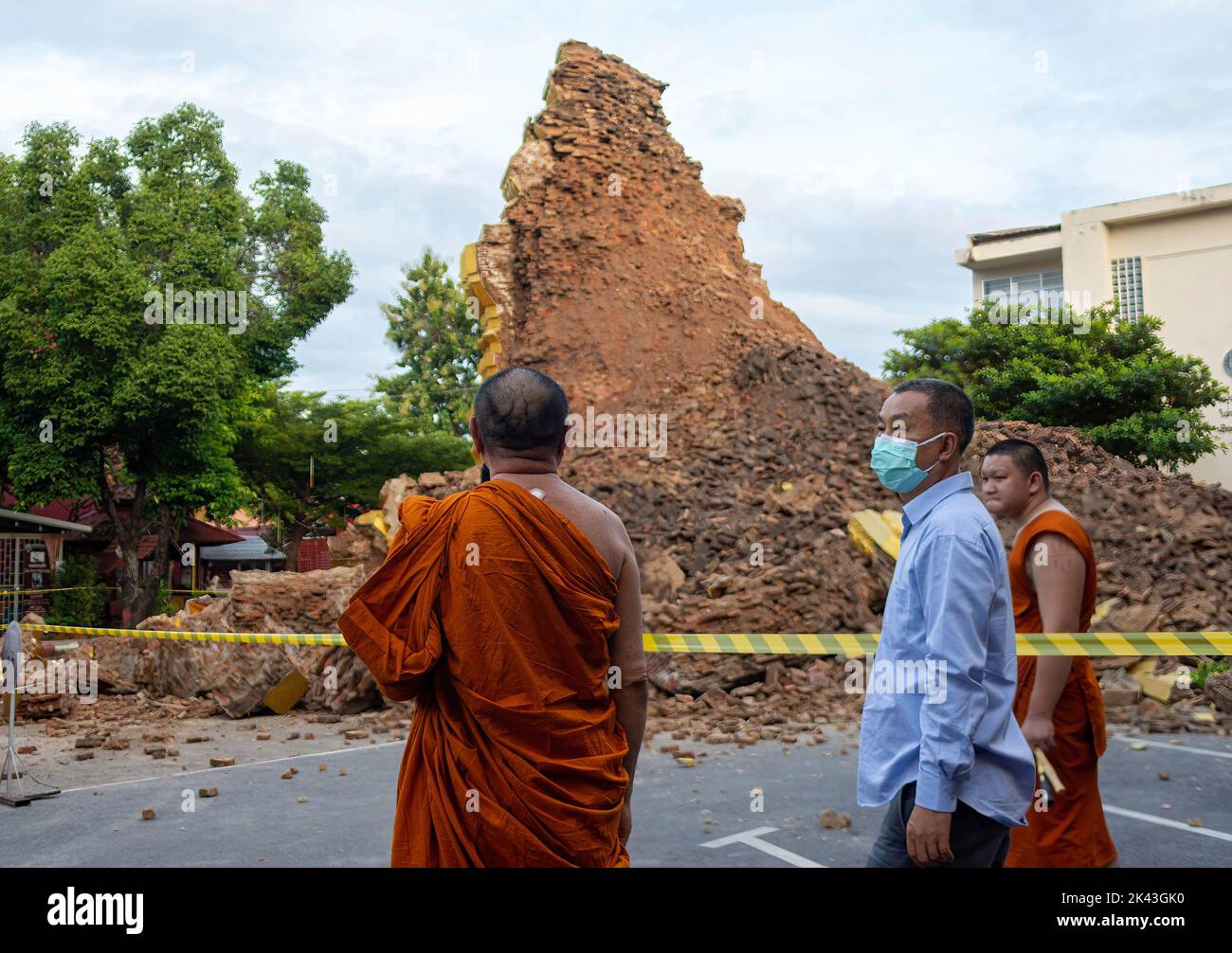 Monks and a worker look at the Ancient Buddhist pagoda a 500-year-old ...