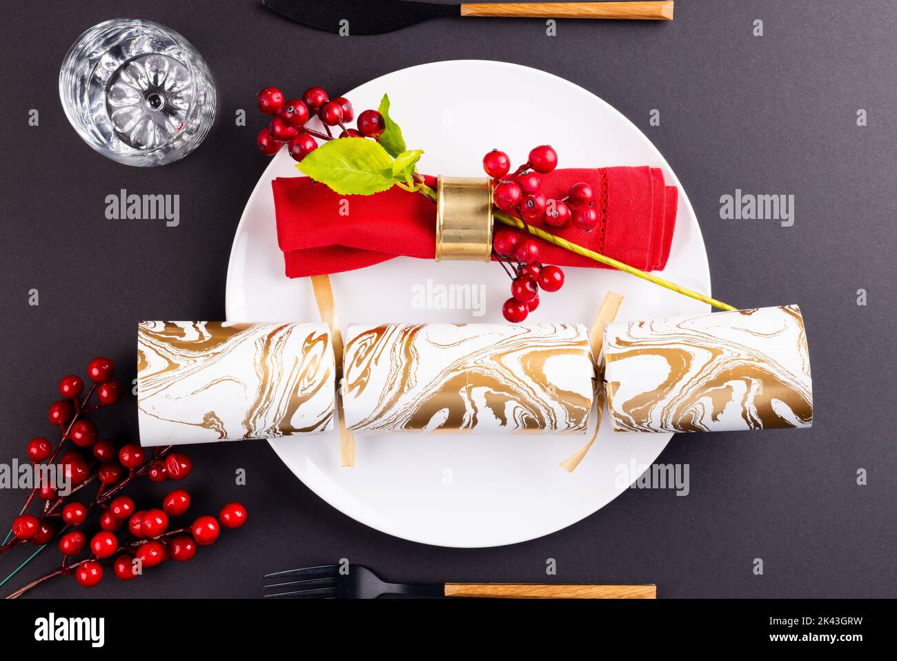 Image of christmas place setting with cutlery and cracker decoration on ...