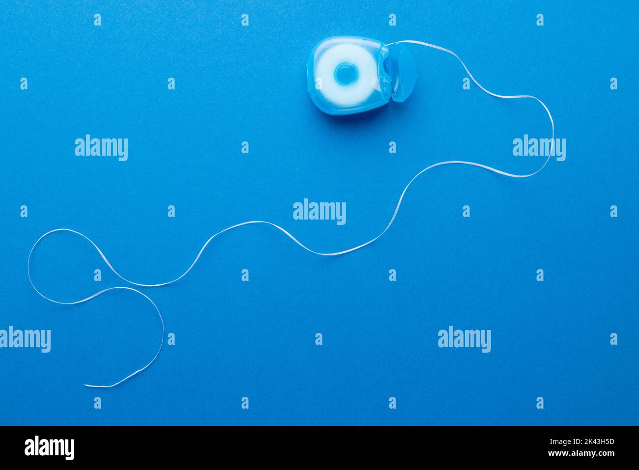 Image of dental string on blue surface Stock Photo - Alamy