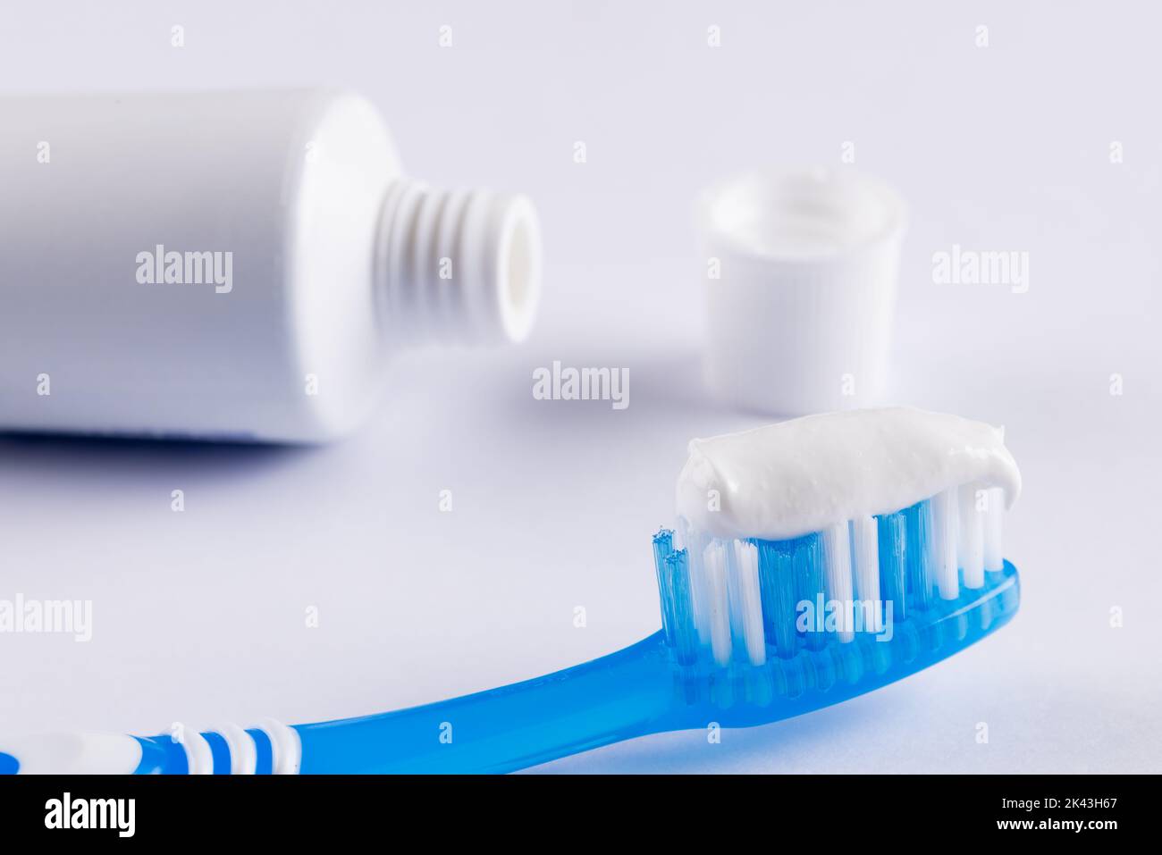 Image of toothbrush and toothpaste on white surface Stock Photo - Alamy