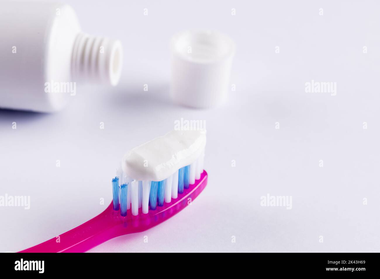 Image of toothbrush and toothpaste on white surface Stock Photo - Alamy