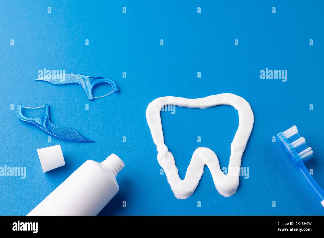 Image of toothbrush, toothpaste, strings and tooth made of paste on ...