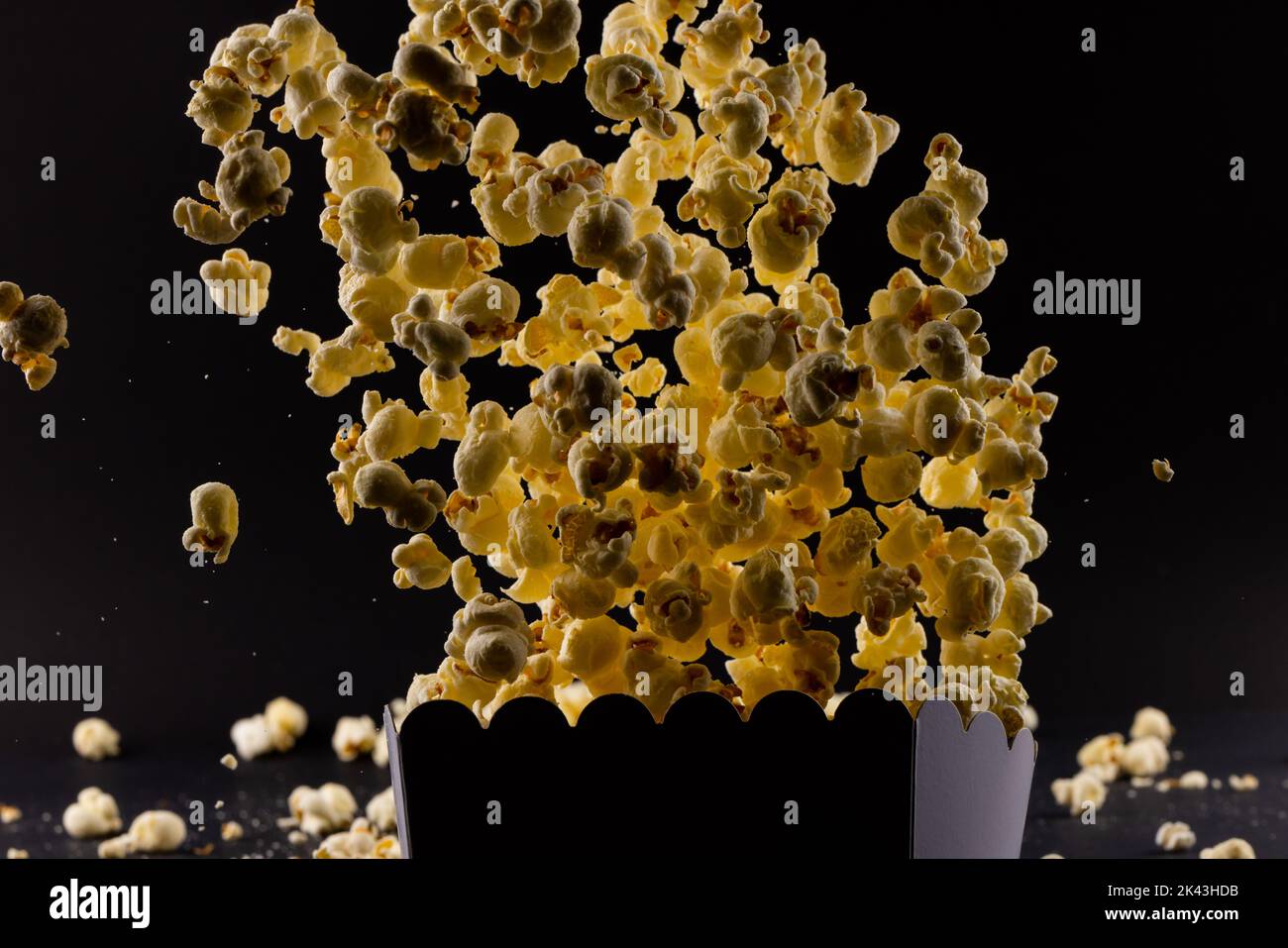 Image of pop corn in box on black background Stock Photo - Alamy