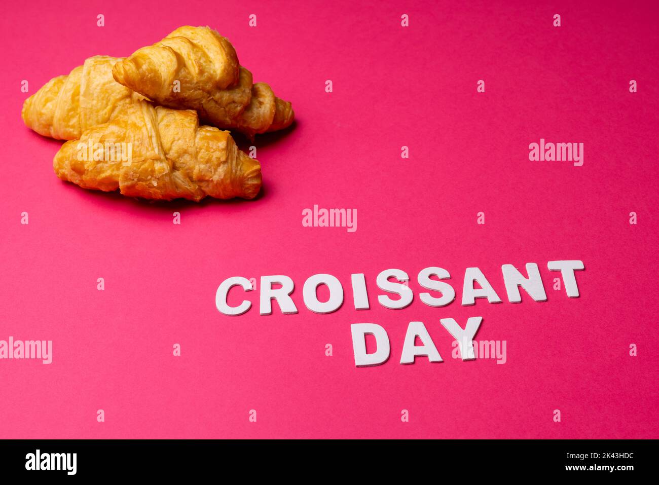Image of croissants and croissant day on pink background Stock Photo ...