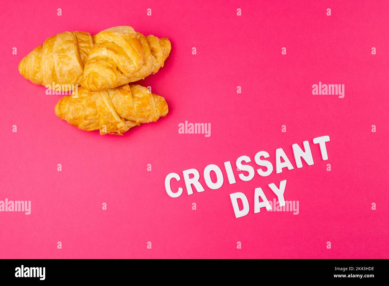 Image of croissants and croissant day on pink background Stock Photo ...