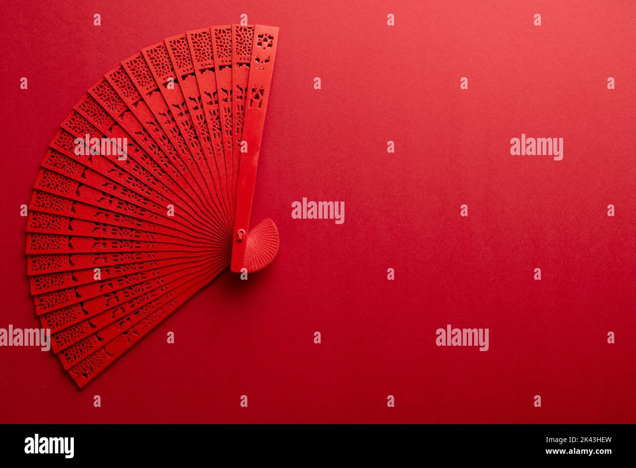 Composition of traditional chinese fan on red background Stock Photo ...