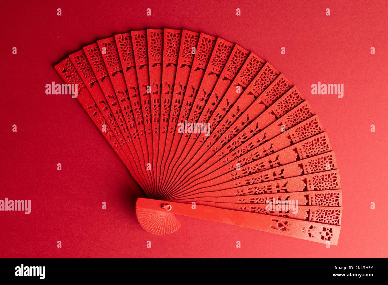 Composition of traditional chinese fan on red background Stock Photo ...
