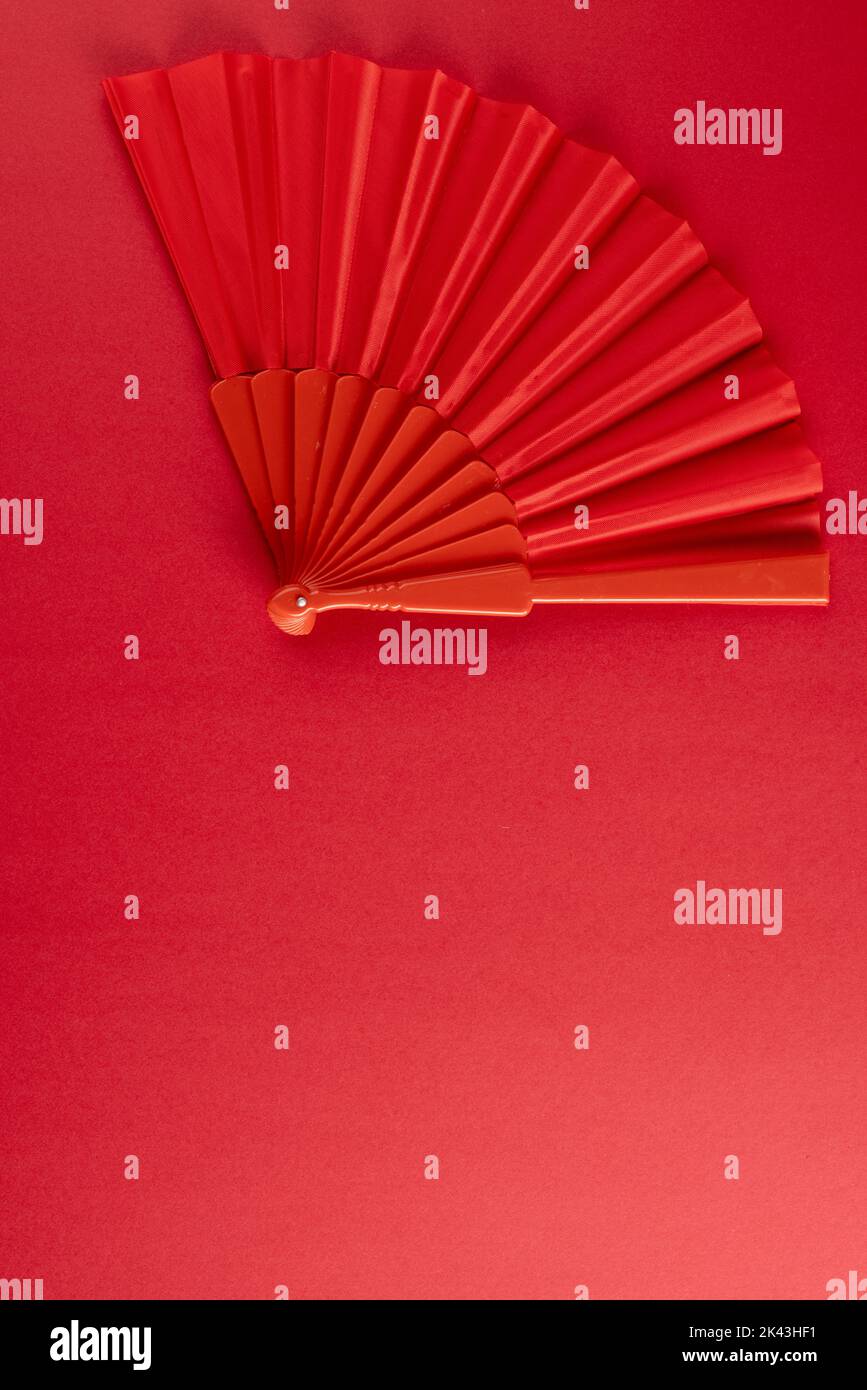Composition of traditional chinese fan on red background Stock Photo ...