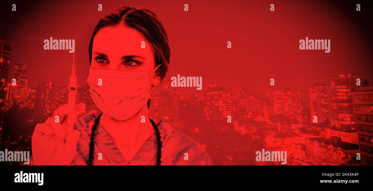 Young brunette woman doctor holding an injection against illuminated ...