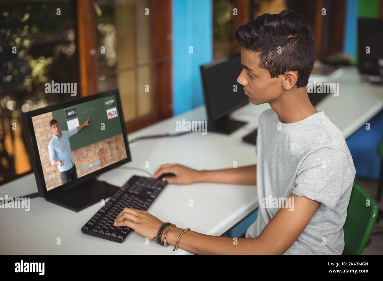 Male indian student having a video call with male teacher on computer ...