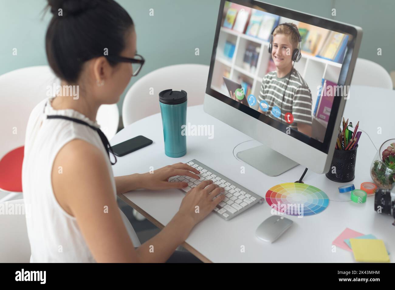 Female teacher having a video call with male student on computer at ...