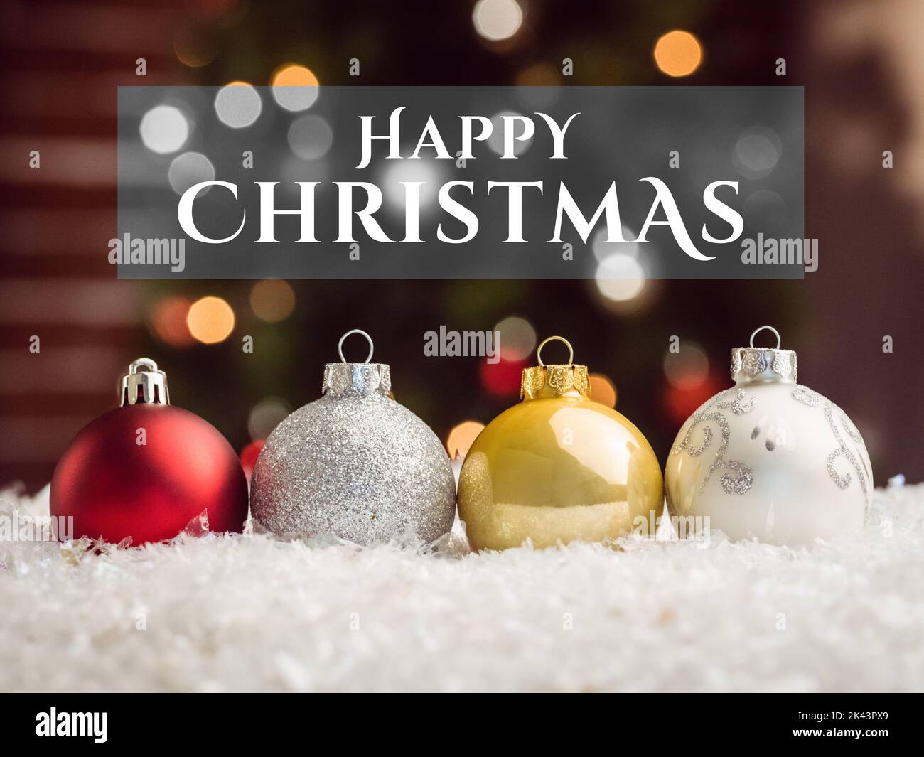 Composition of christmas text over baubles on snow background Stock ...