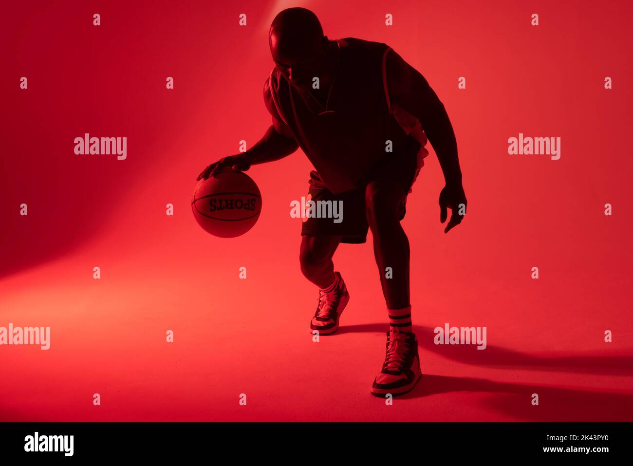 Image of african american basketball player bouncing basketball on neon ...