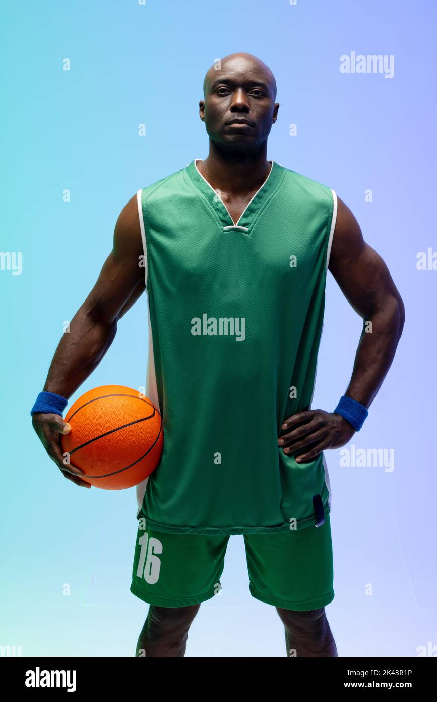 Image of african american basketball player with basketball on green to ...