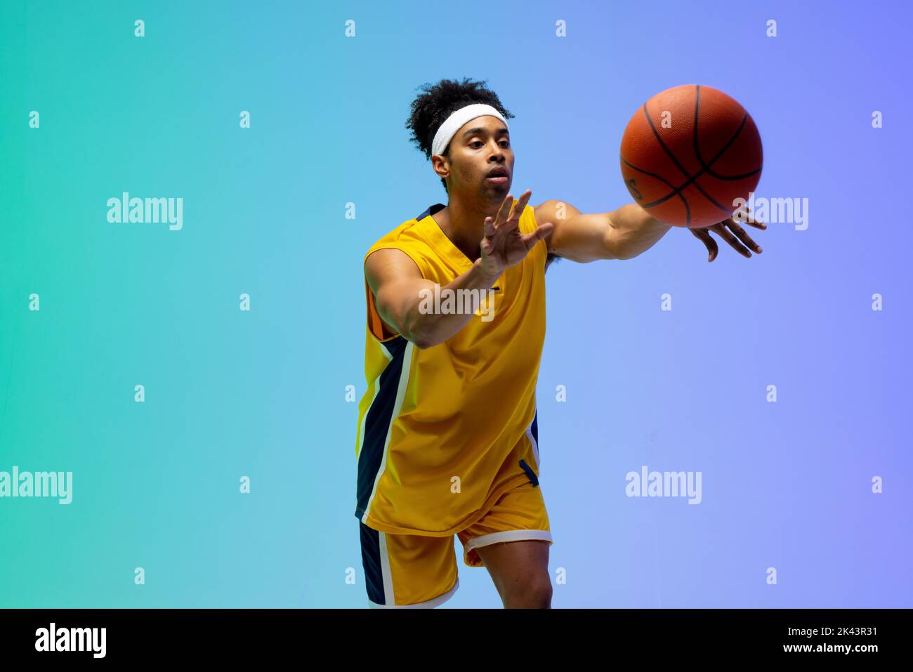 Image of biracial basketball player throwing basketball on green to ...