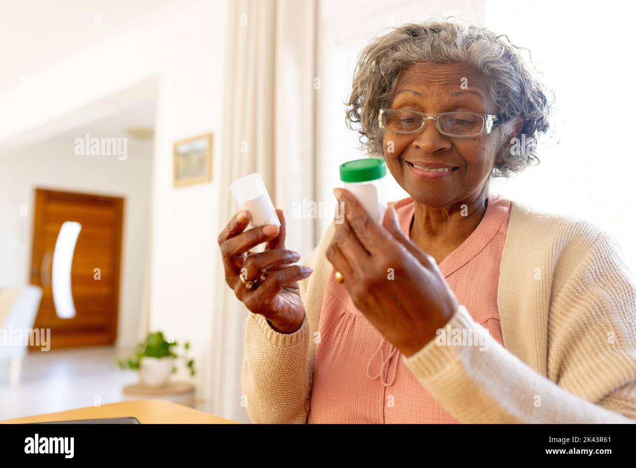 Happy senior african american women taking her medications Stock Photo ...