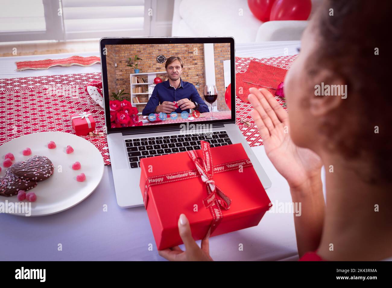 Diverse couple making valentines date video call using laptop the woman ...