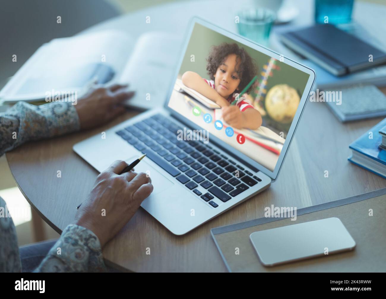 Mixed race schoolboy learning displayed on laptop screen during video ...