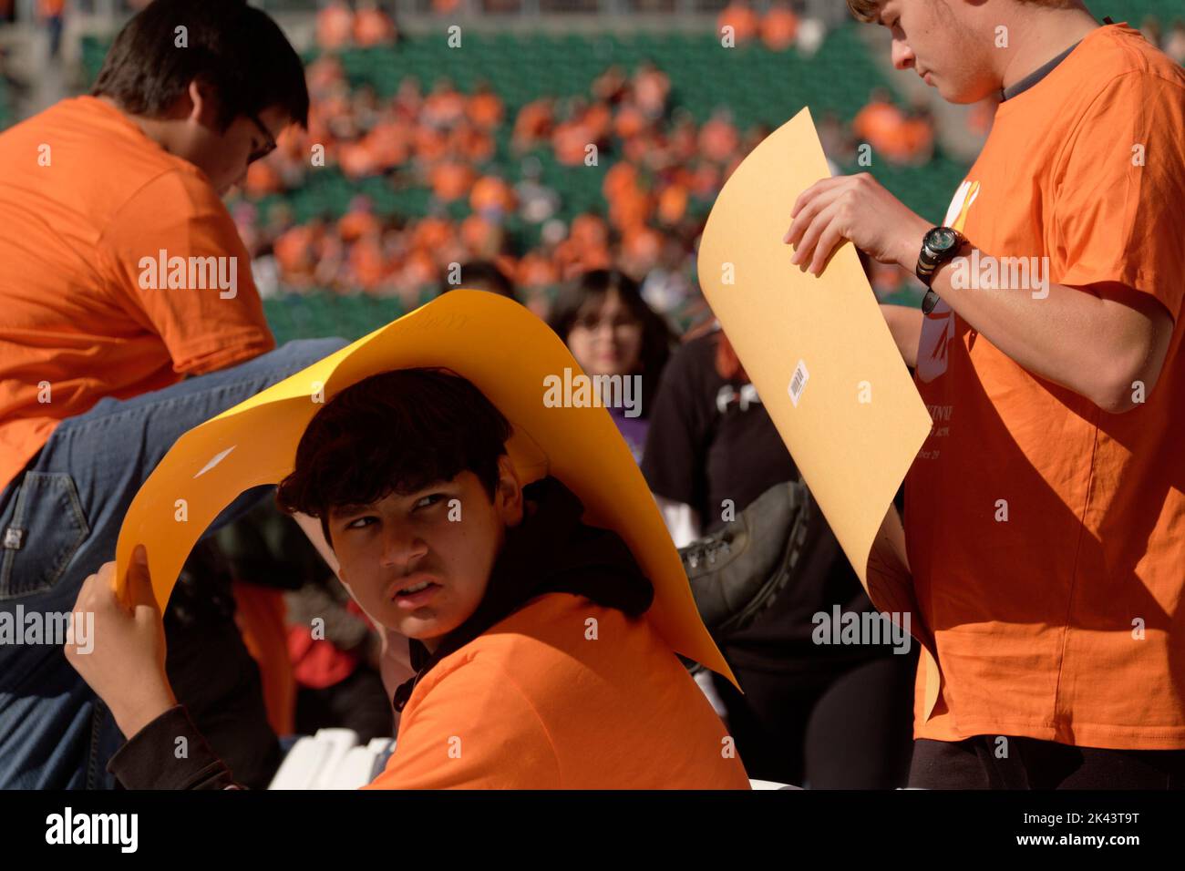 Joseph Durocher from Scott Collegiate uses a placard to get shade ...
