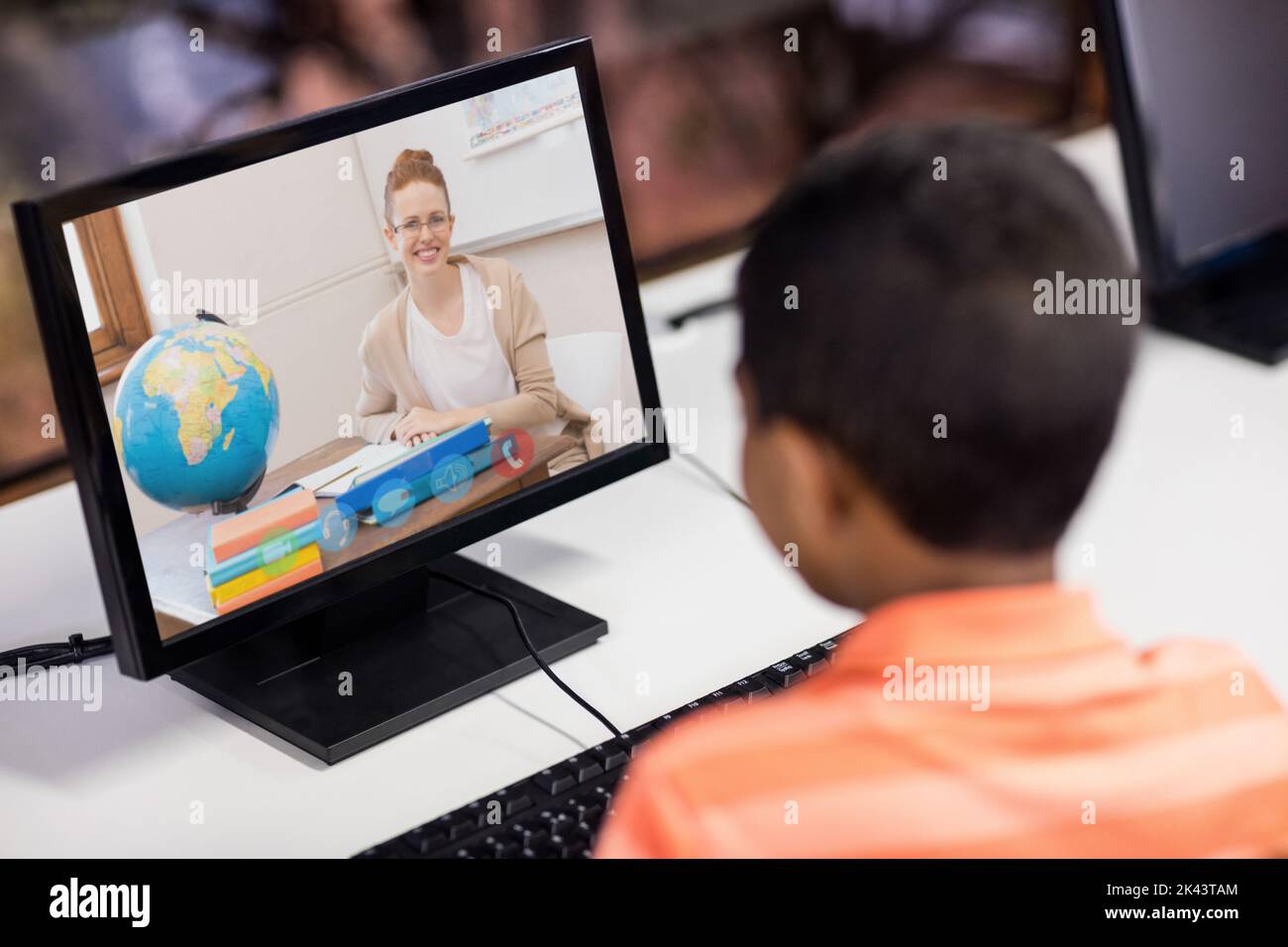 Male student having a video call with female teacher on computer at ...