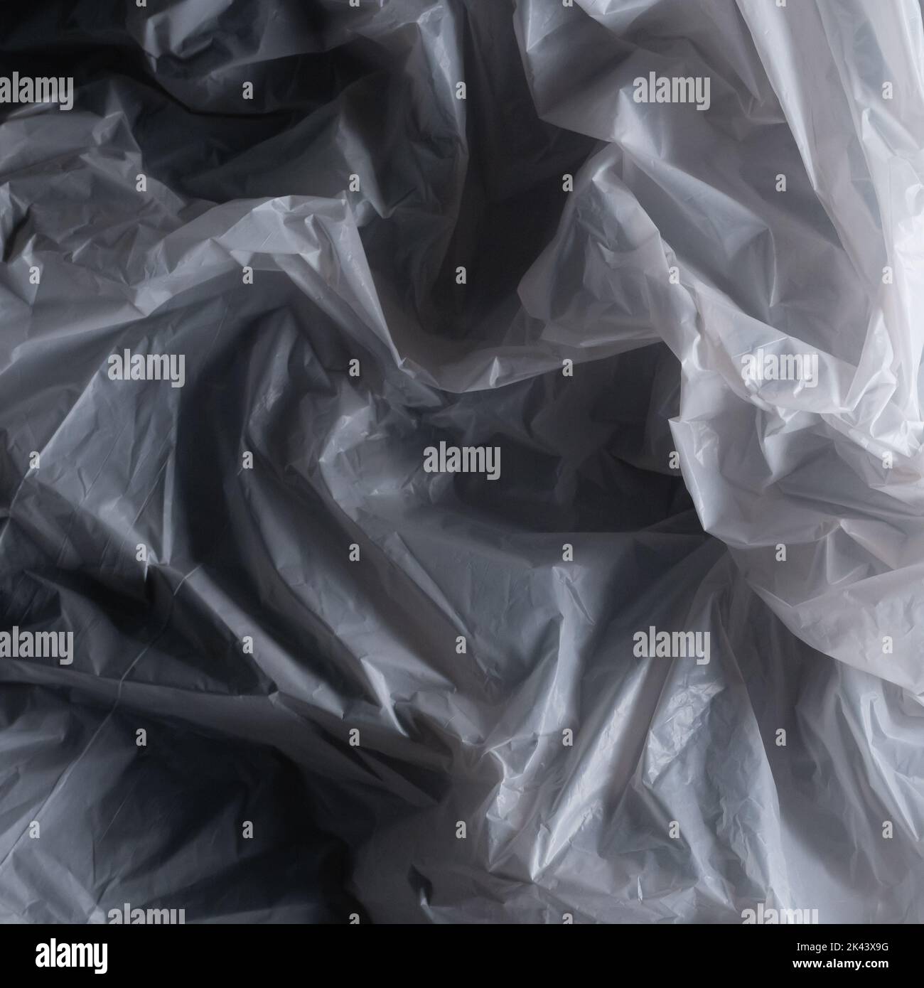 Reflecting light and shadow on creases and folds in scrunched thin ...