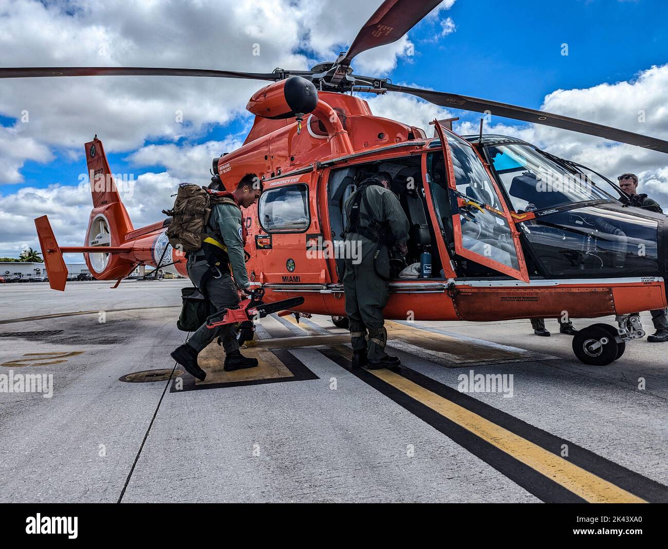 A U.S. Coast Guard MH-65 Dolphin crew from Air Station Miami, Florida ...