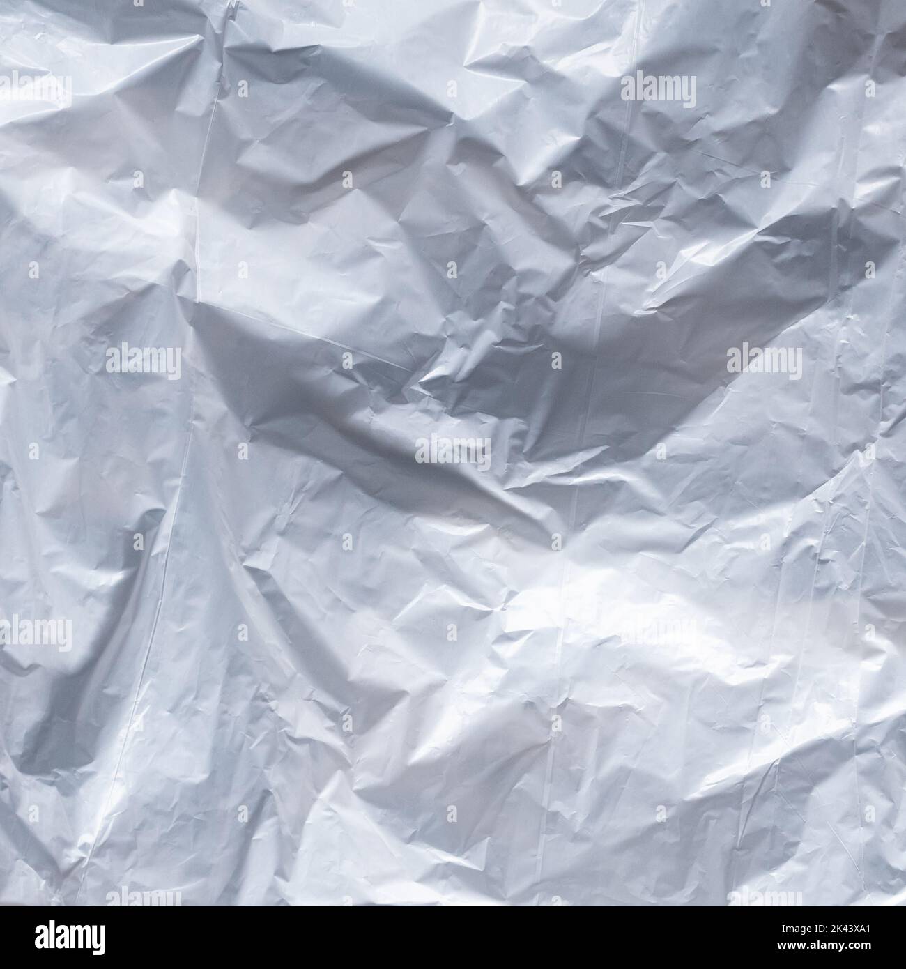 Reflecting light and shadow on creases and folds in scrunched white ...