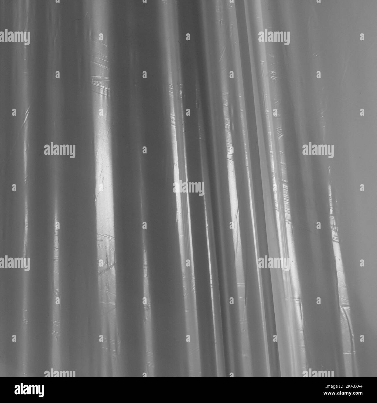 Reflecting light and shadow on pleats and folds in stretched plastic ...