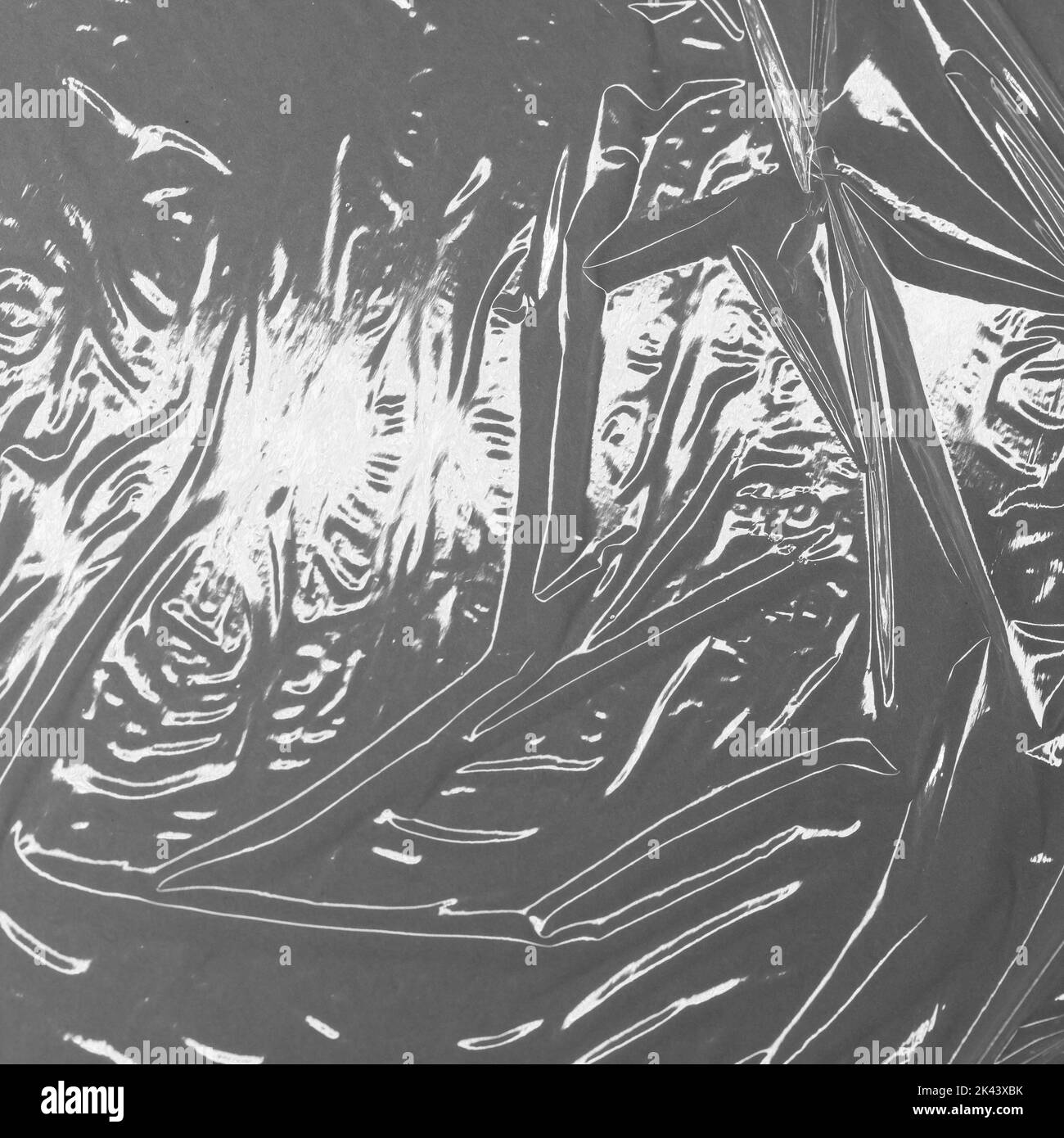 Reflected light and shadow on folds and creases in plastic sheeting ...